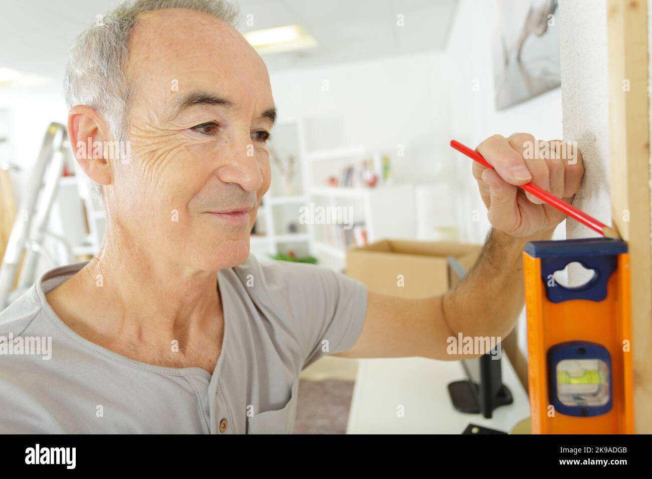 senior man working with spirit level Stock Photo - Alamy