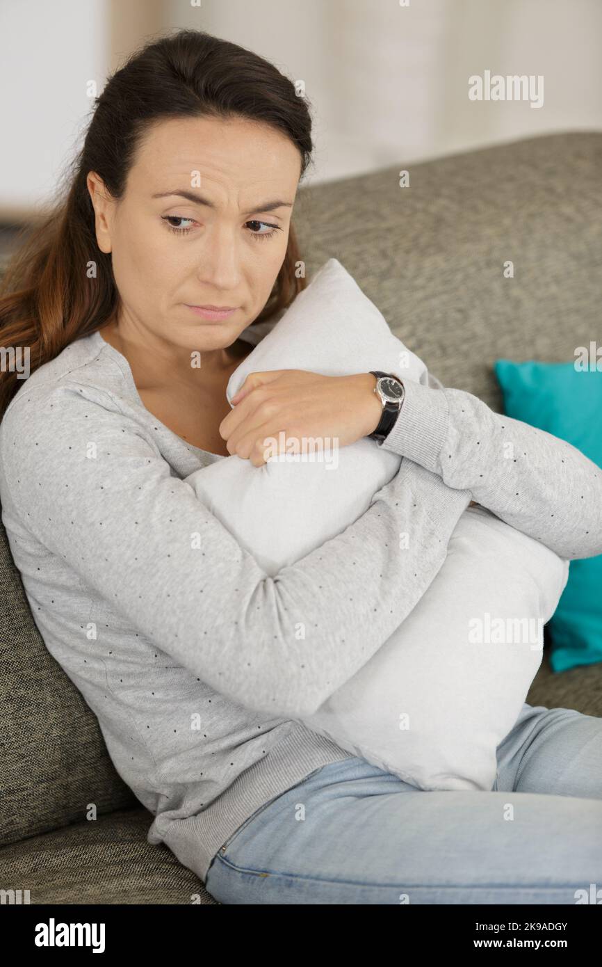 emotional woman cuddling a cushion Stock Photo - Alamy