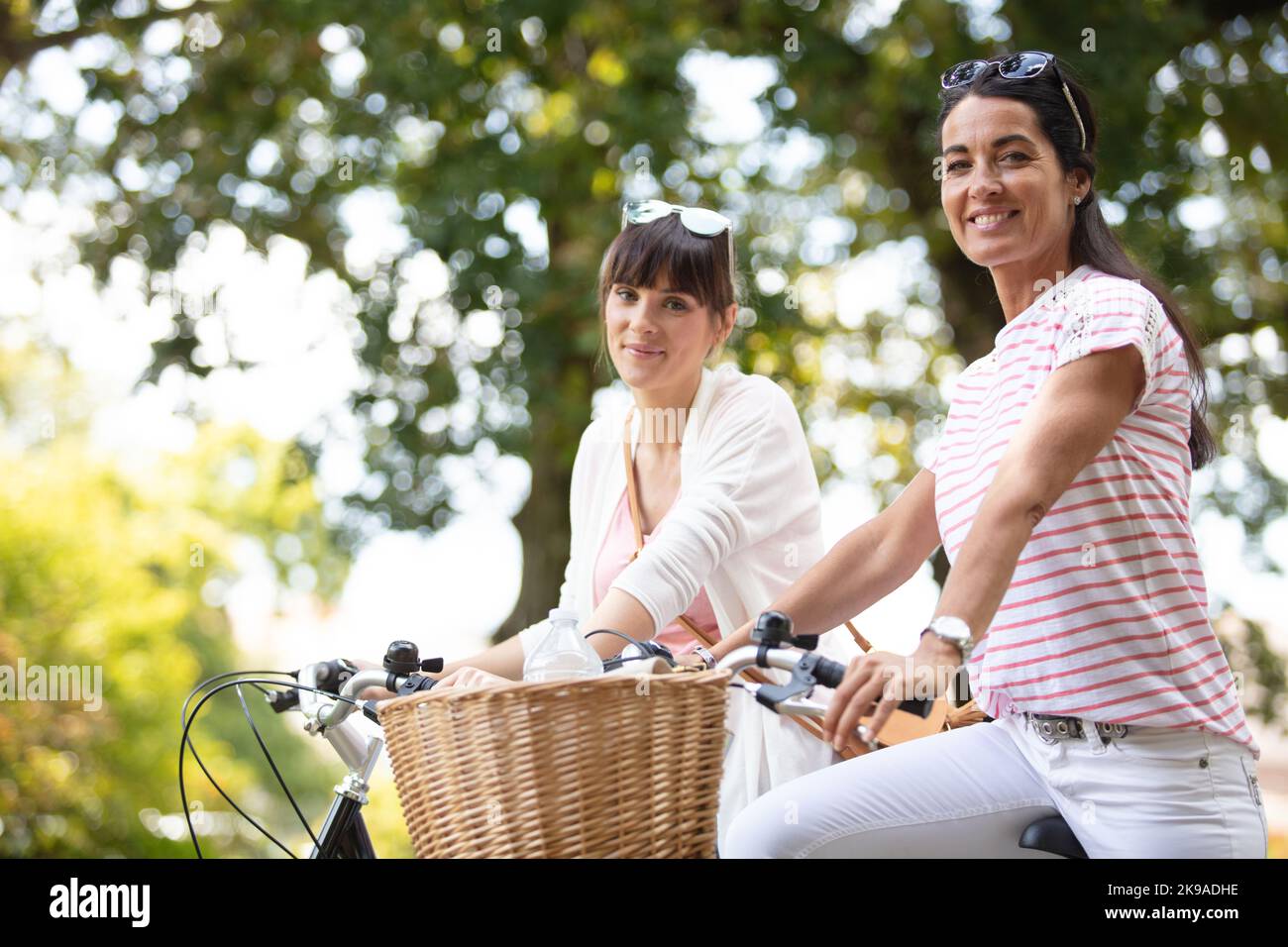 two friends on bikes outdoors smiling Stock Photo - Alamy