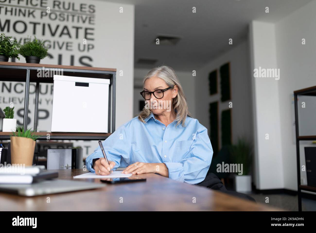 Middle aged older business woman of European appearance works as a ...