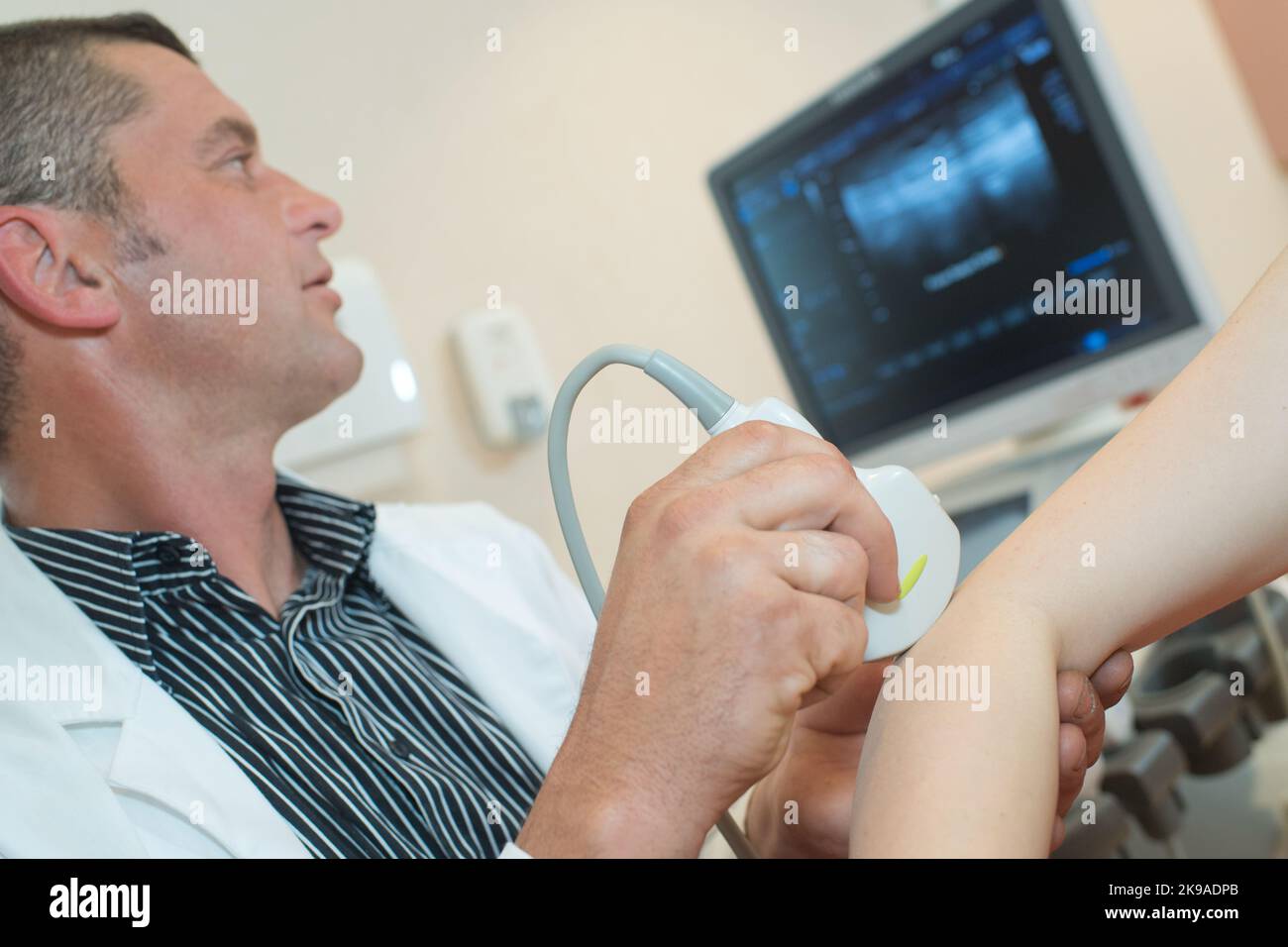 doctor performing ultrasound on arm Stock Photo - Alamy