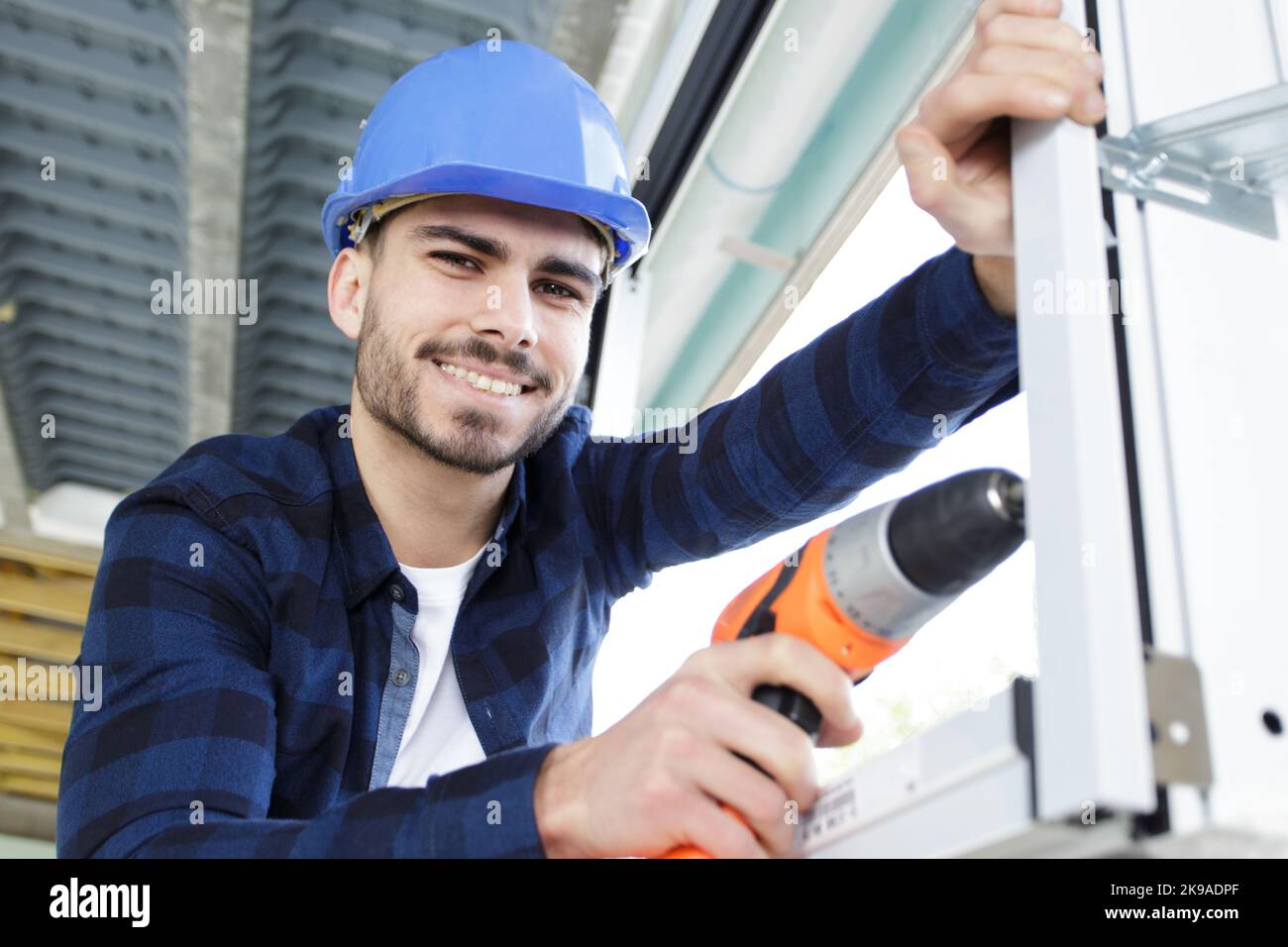 happy man installing roller shutter on window Stock Photo - Alamy