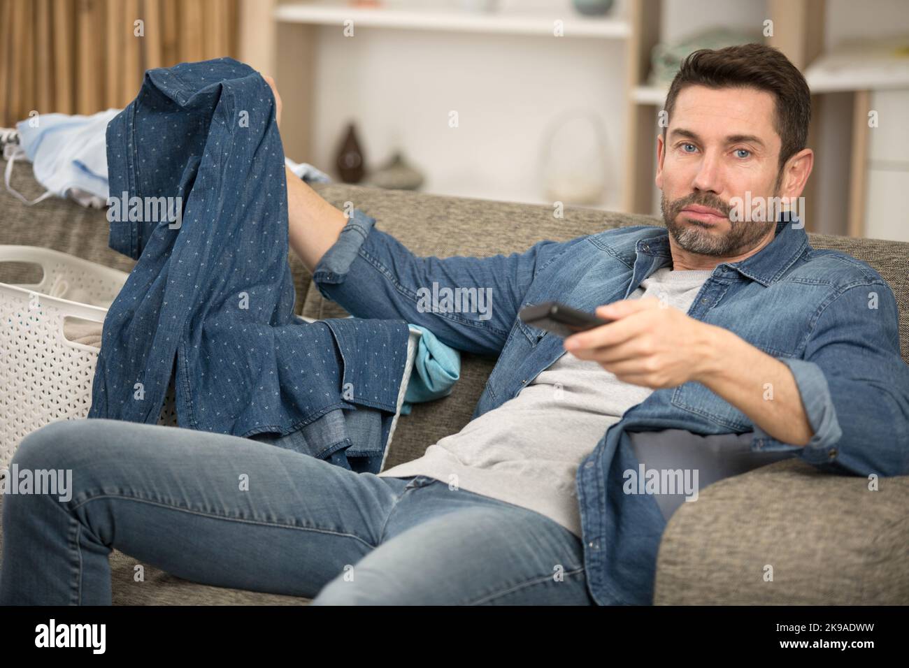 upset man has to do the ironing at home Stock Photo - Alamy