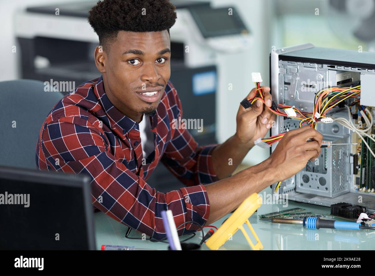 a young computer engineer connecting cables Stock Photo - Alamy