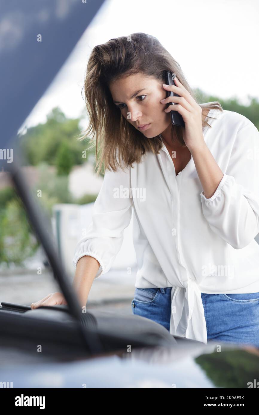 woman the car is broken open the bonnet check engine Stock Photo - Alamy