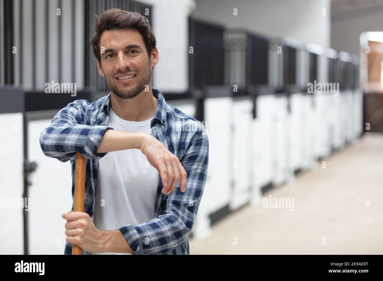 farmer cleaning a modern stable Stock Photo - Alamy