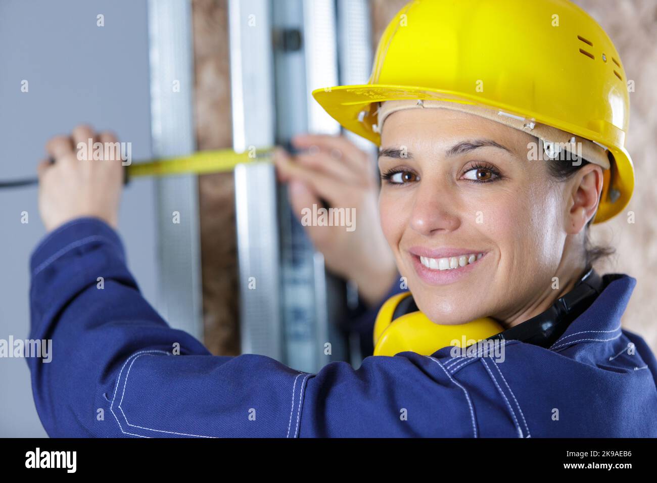 woman worker measuring dimensions on plasterboard panel Stock Photo - Alamy
