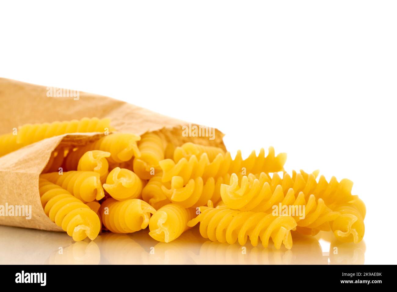 Durum wheat pasta in a kraft paper bag, macro, isolated on white ...