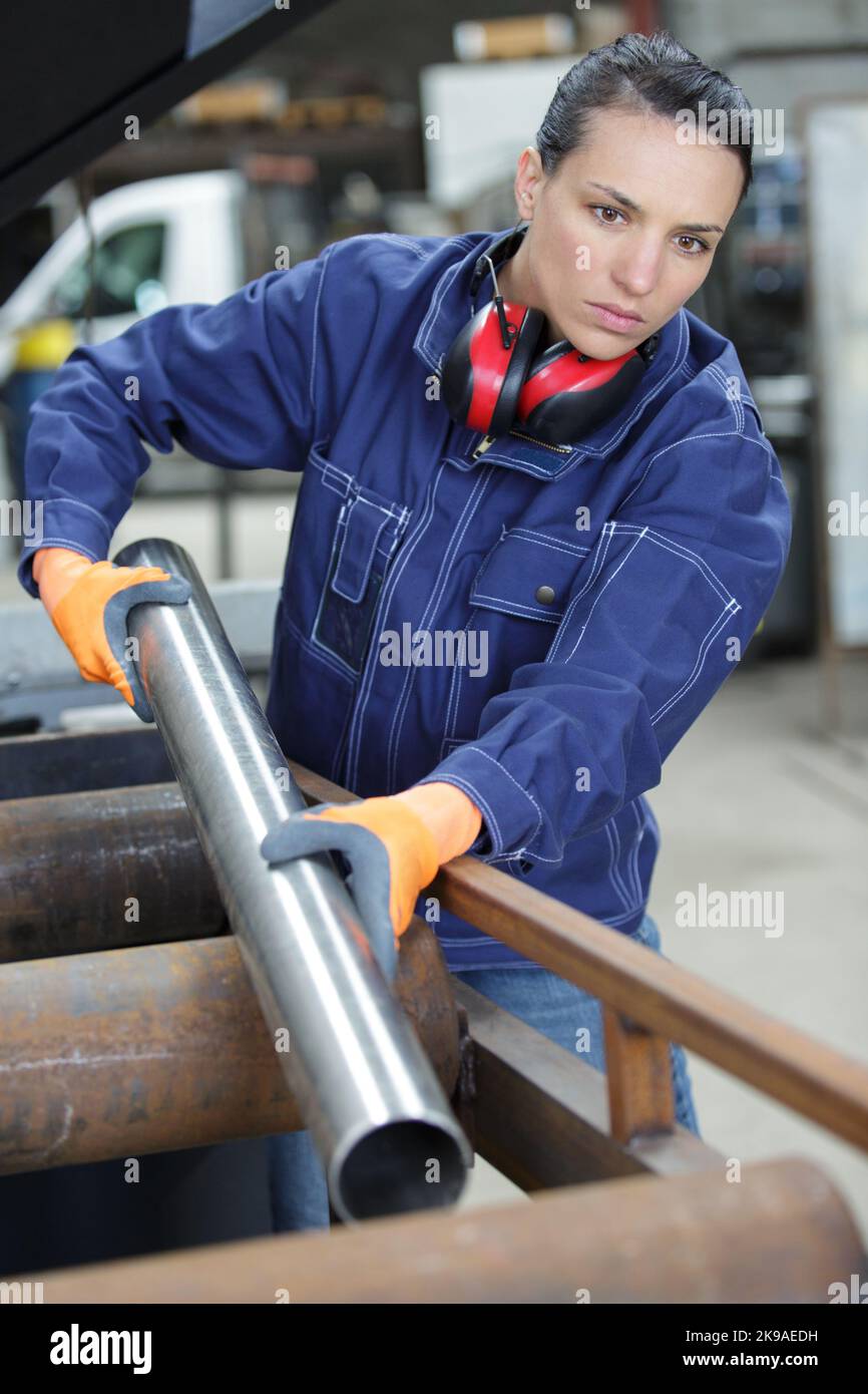female handling machinery in a metal workshop Stock Photo - Alamy
