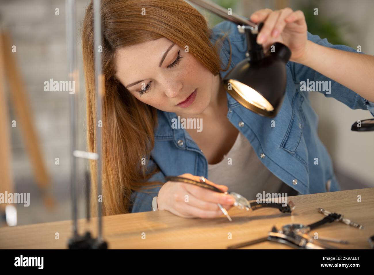 female is fixing a watch Stock Photo - Alamy