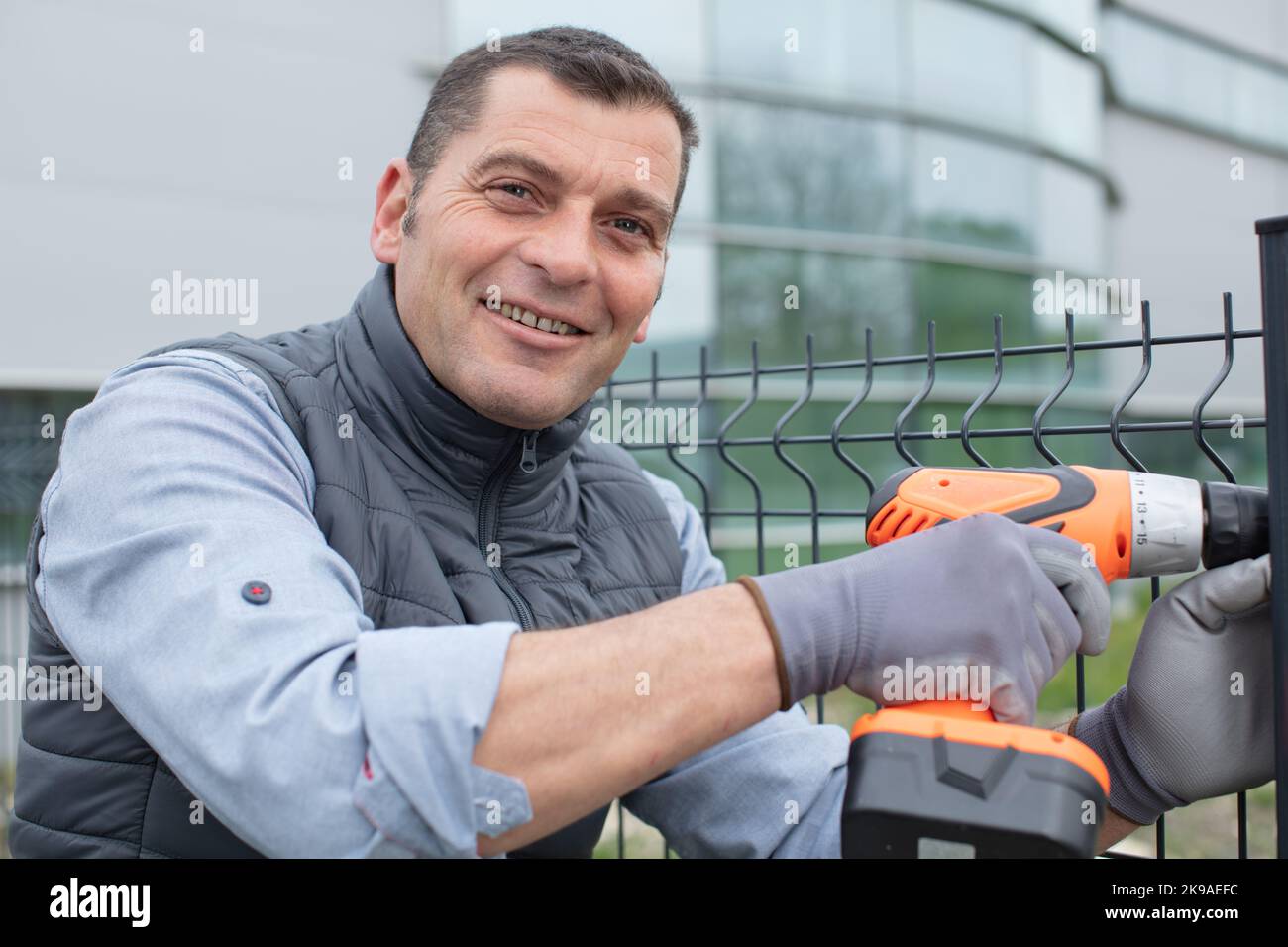 construction man working with cordless electrical screwdriver on metal ...