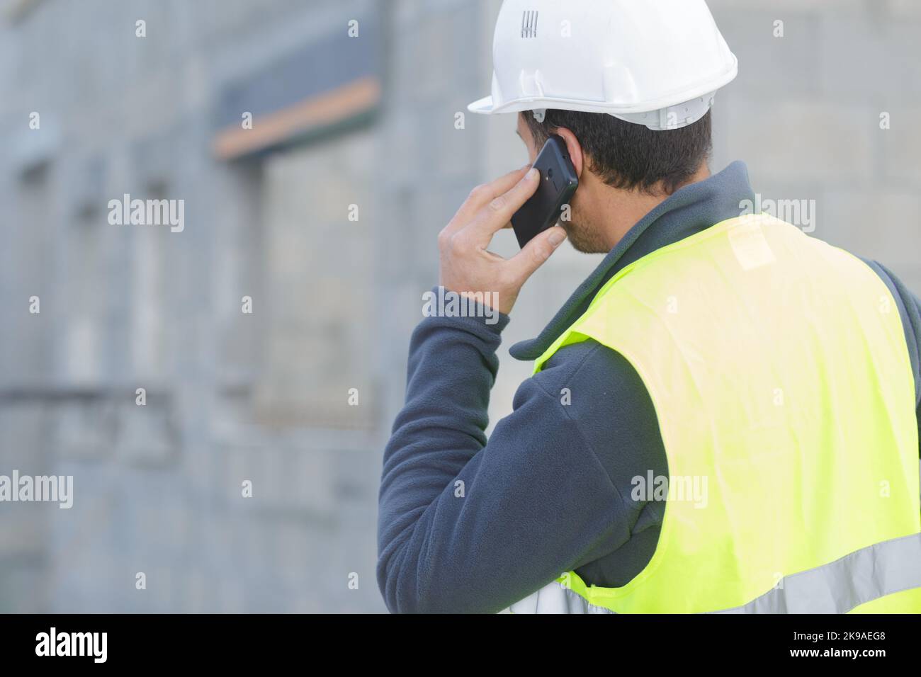 builder calling by smartphone in a construction site Stock Photo - Alamy
