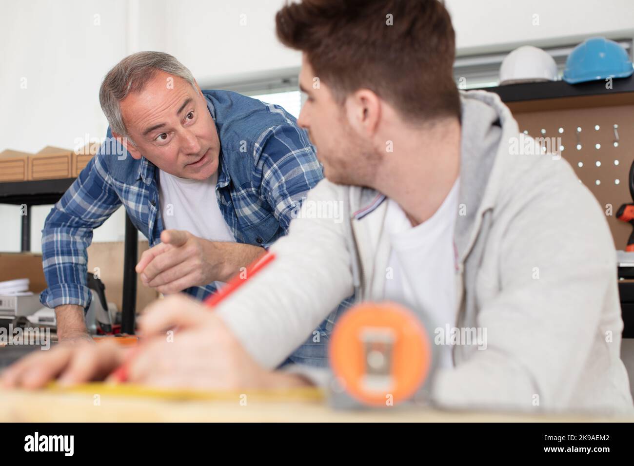engineer showing apprentice how to work Stock Photo - Alamy