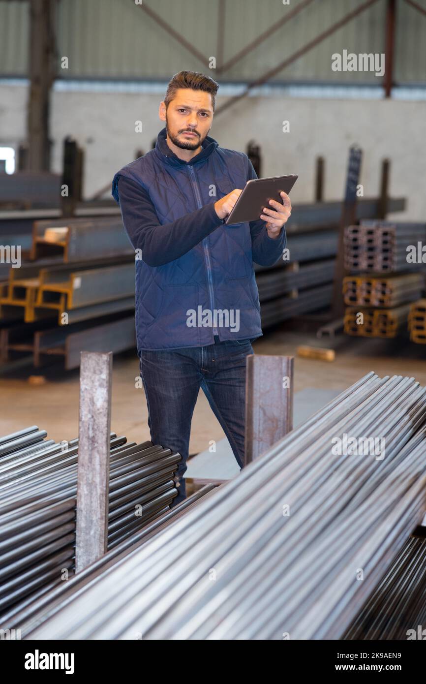 metalworker controls some metal bars in steel mill Stock Photo - Alamy