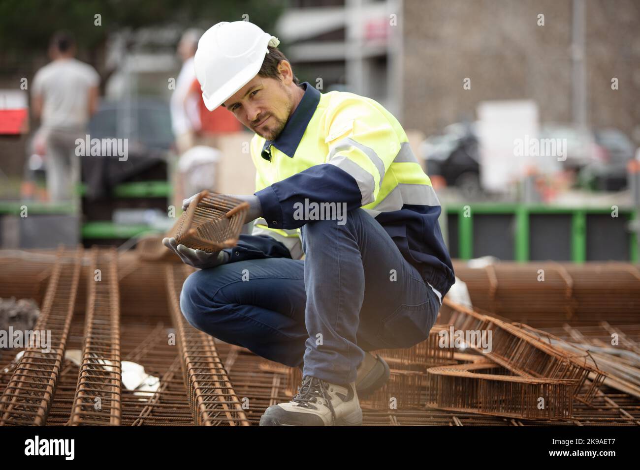 tradesman testing straightness of reinforcement bars Stock Photo - Alamy
