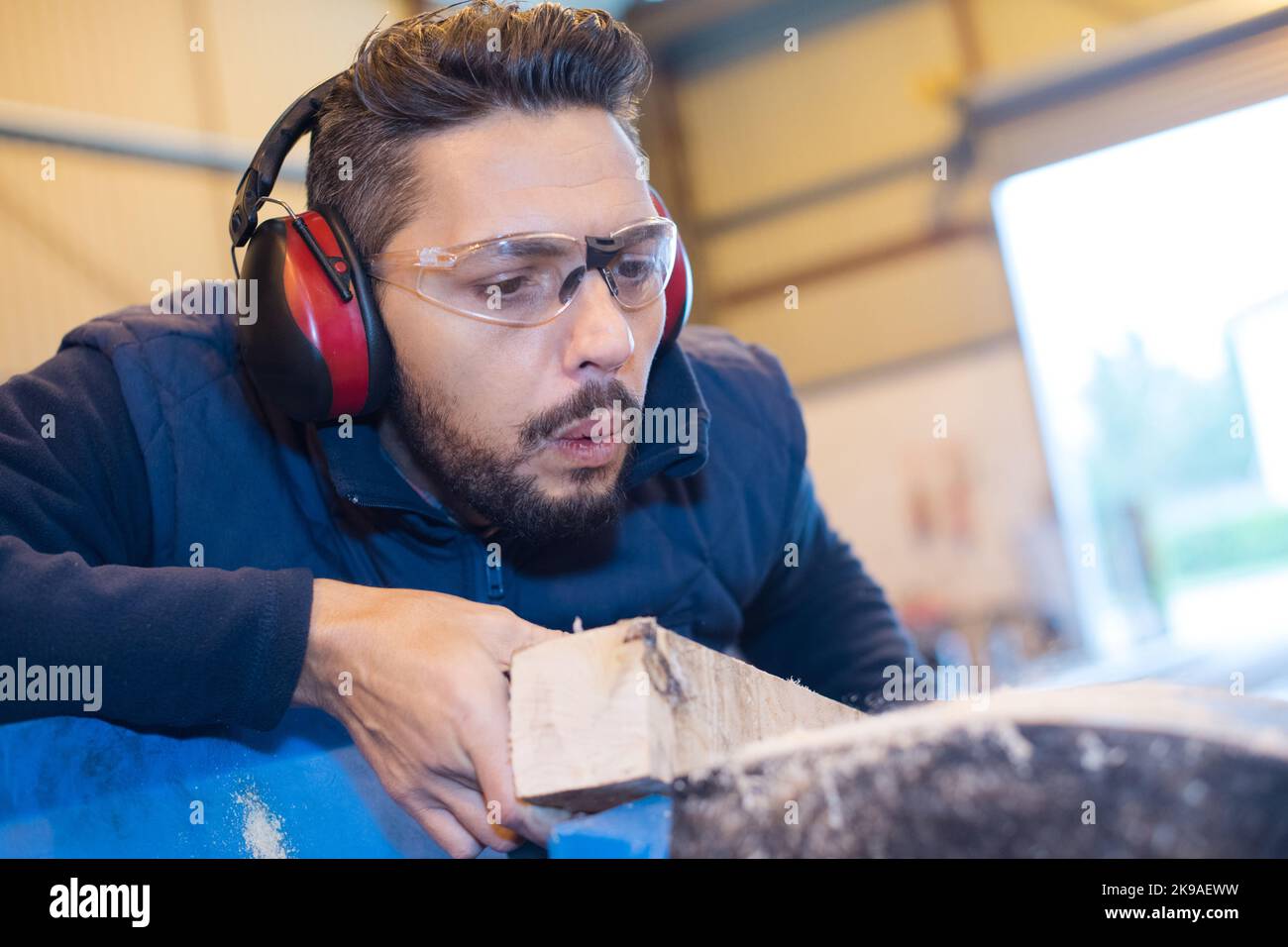 carpenter using power-tool for cutting wood Stock Photo - Alamy