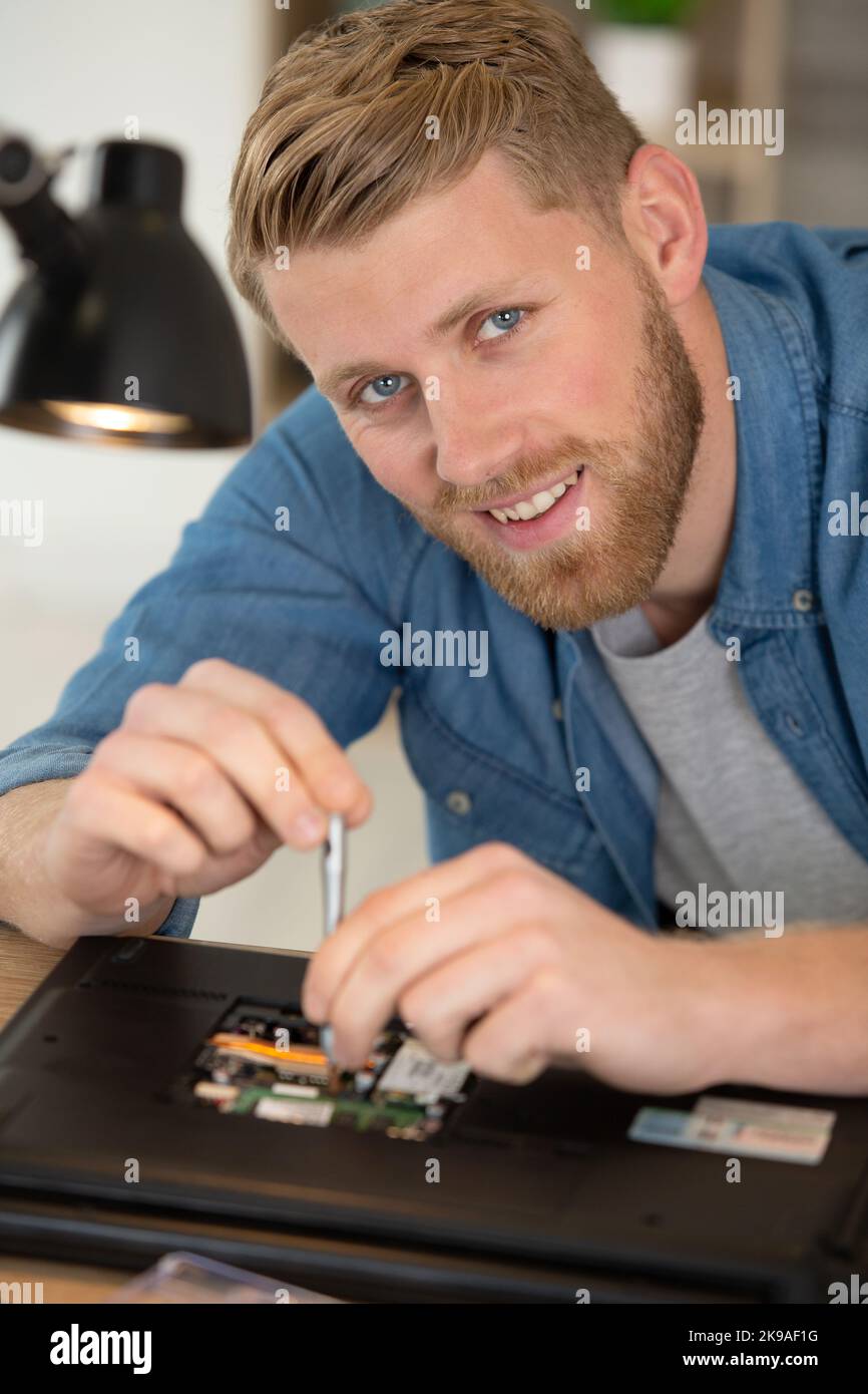 Notebook man repairing hi-res stock photography and images - Alamy