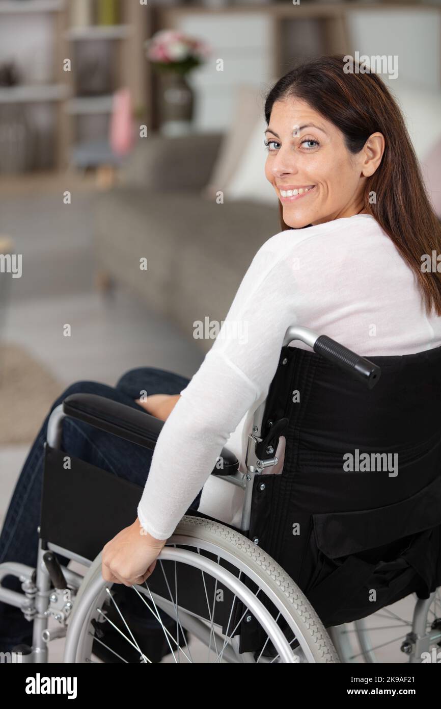 beautiful woman in her wheelchair at home Stock Photo - Alamy