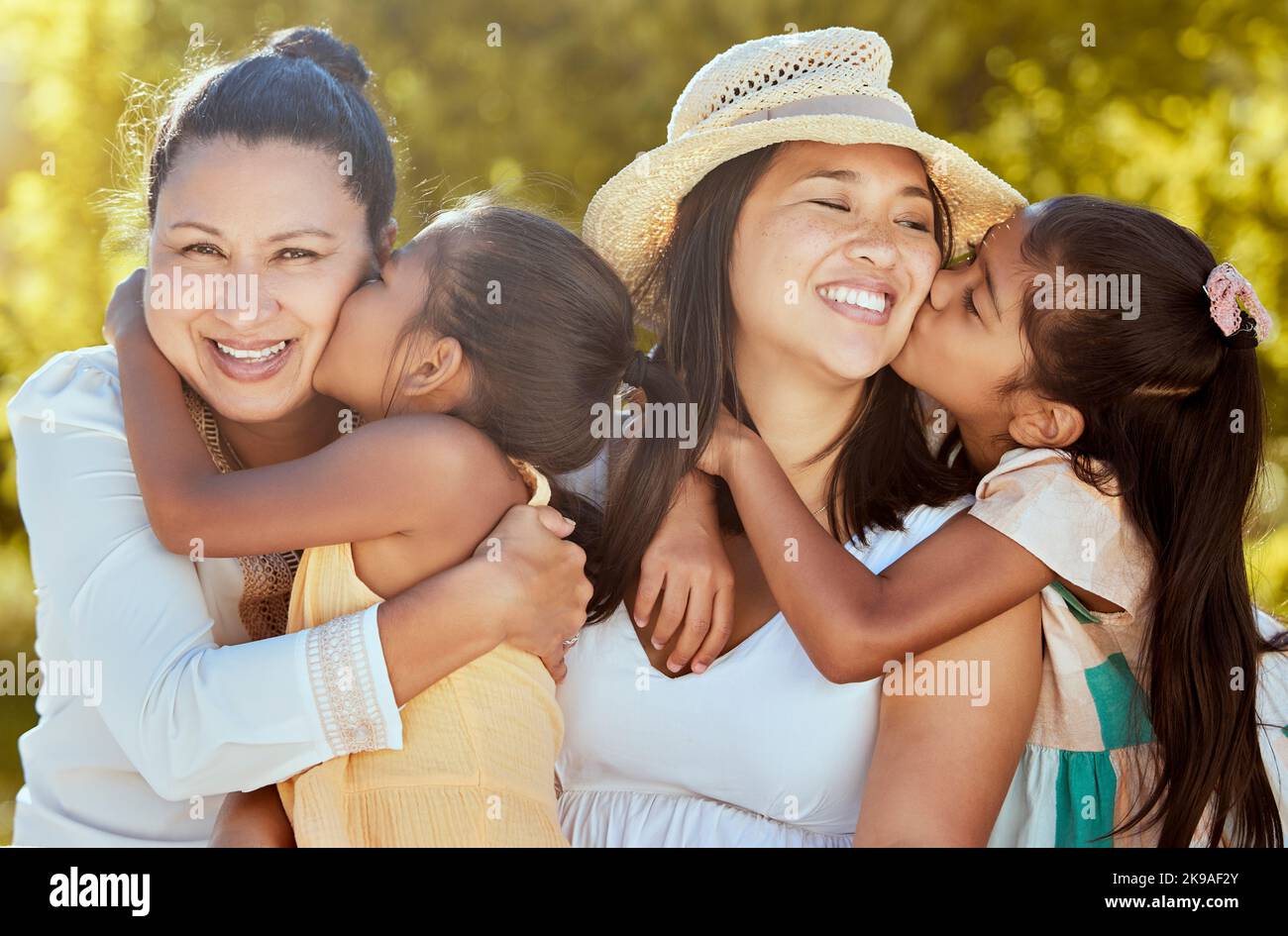 Women, family and face kids kiss in a nature park with mother and ...