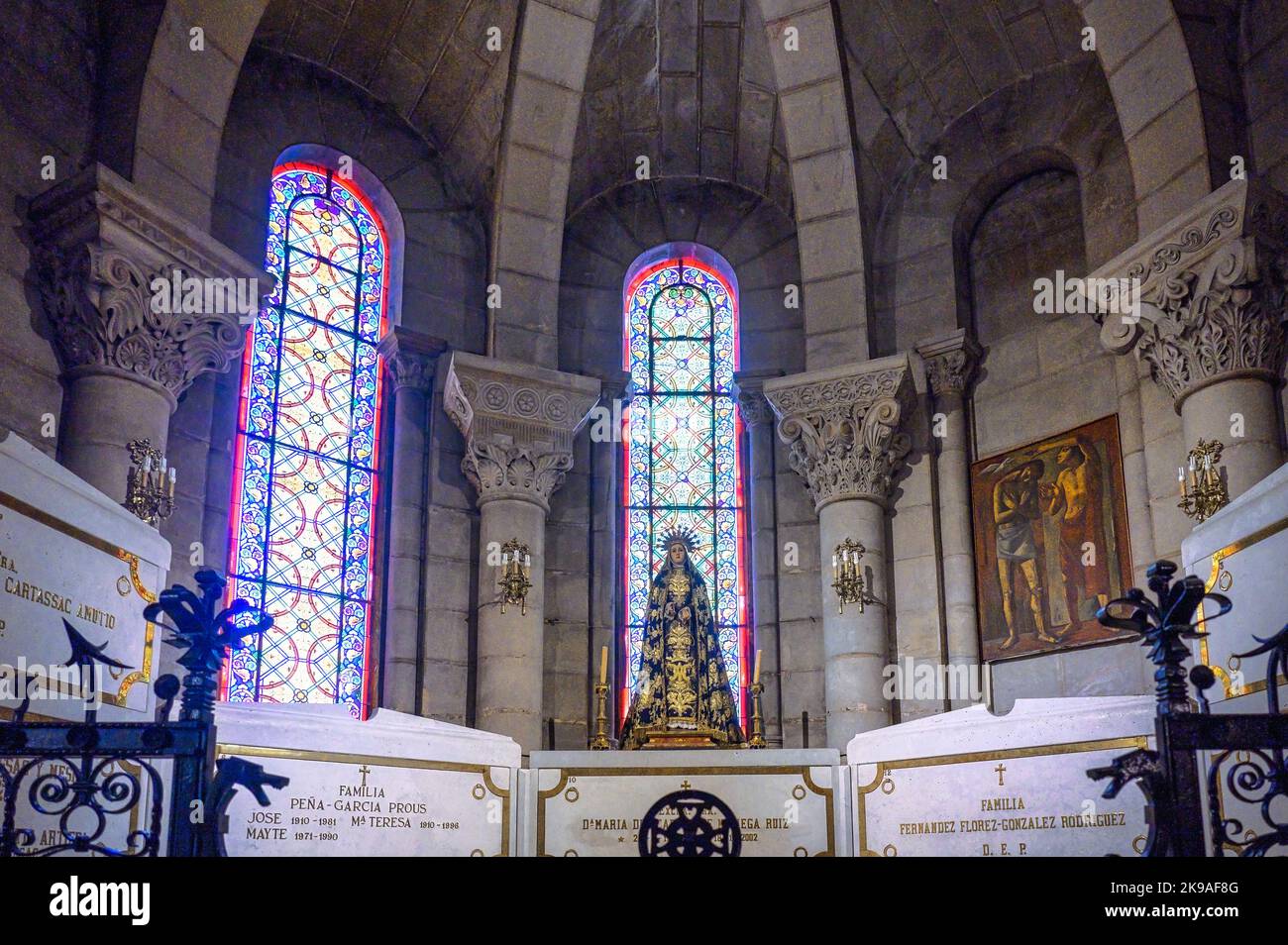 Virgin Mary over tumbs with stained glass skylights in the background ...