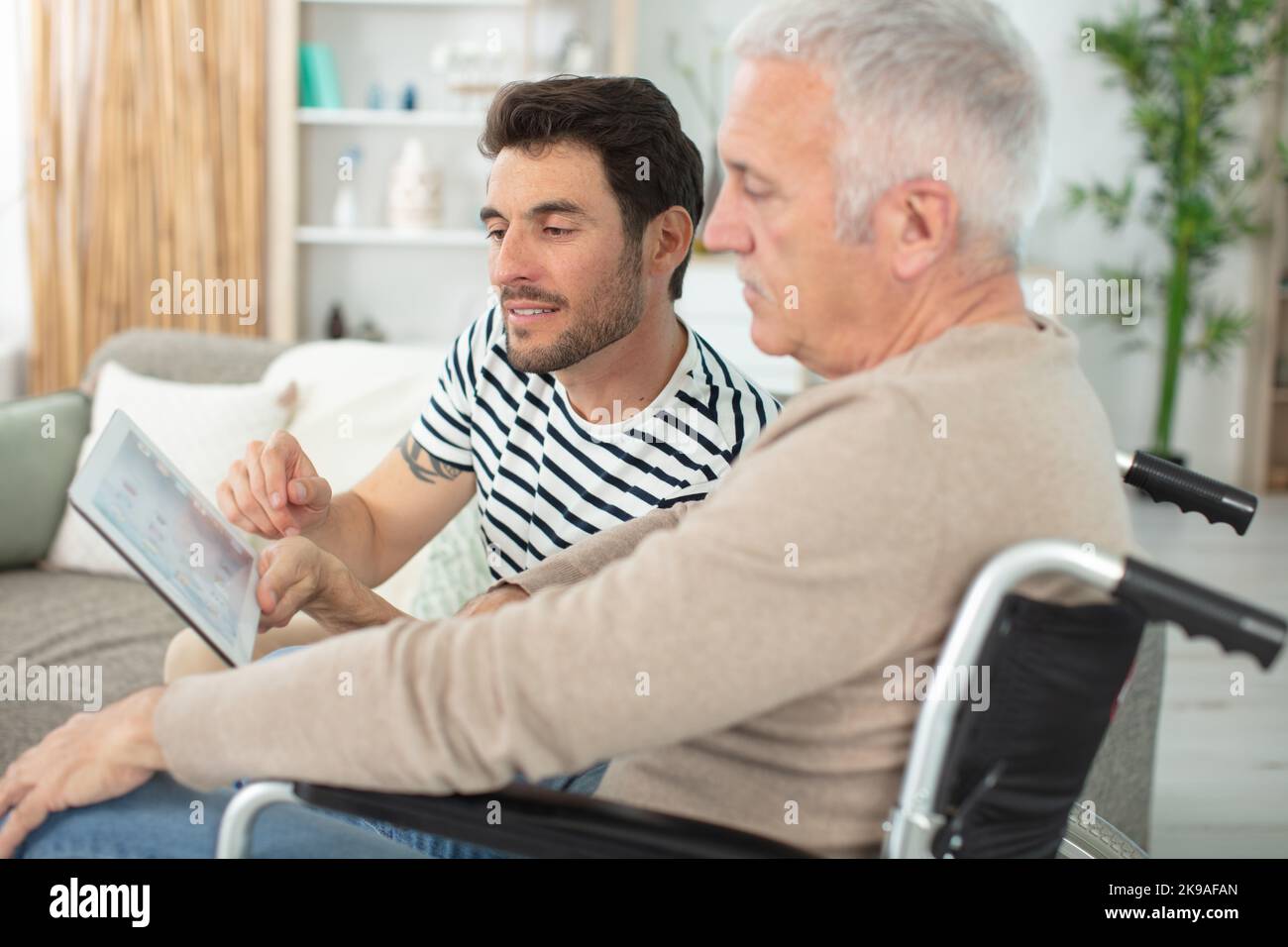 Father walking disabled son in hi-res stock photography and images - Alamy