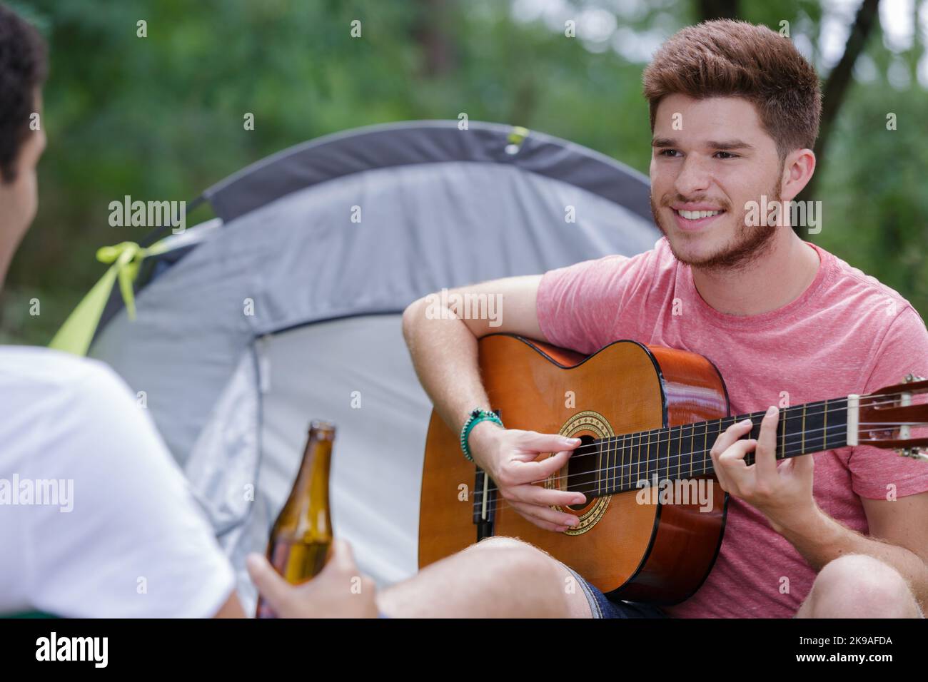 inspired young guitarist playing guitar on camp Stock Photo - Alamy