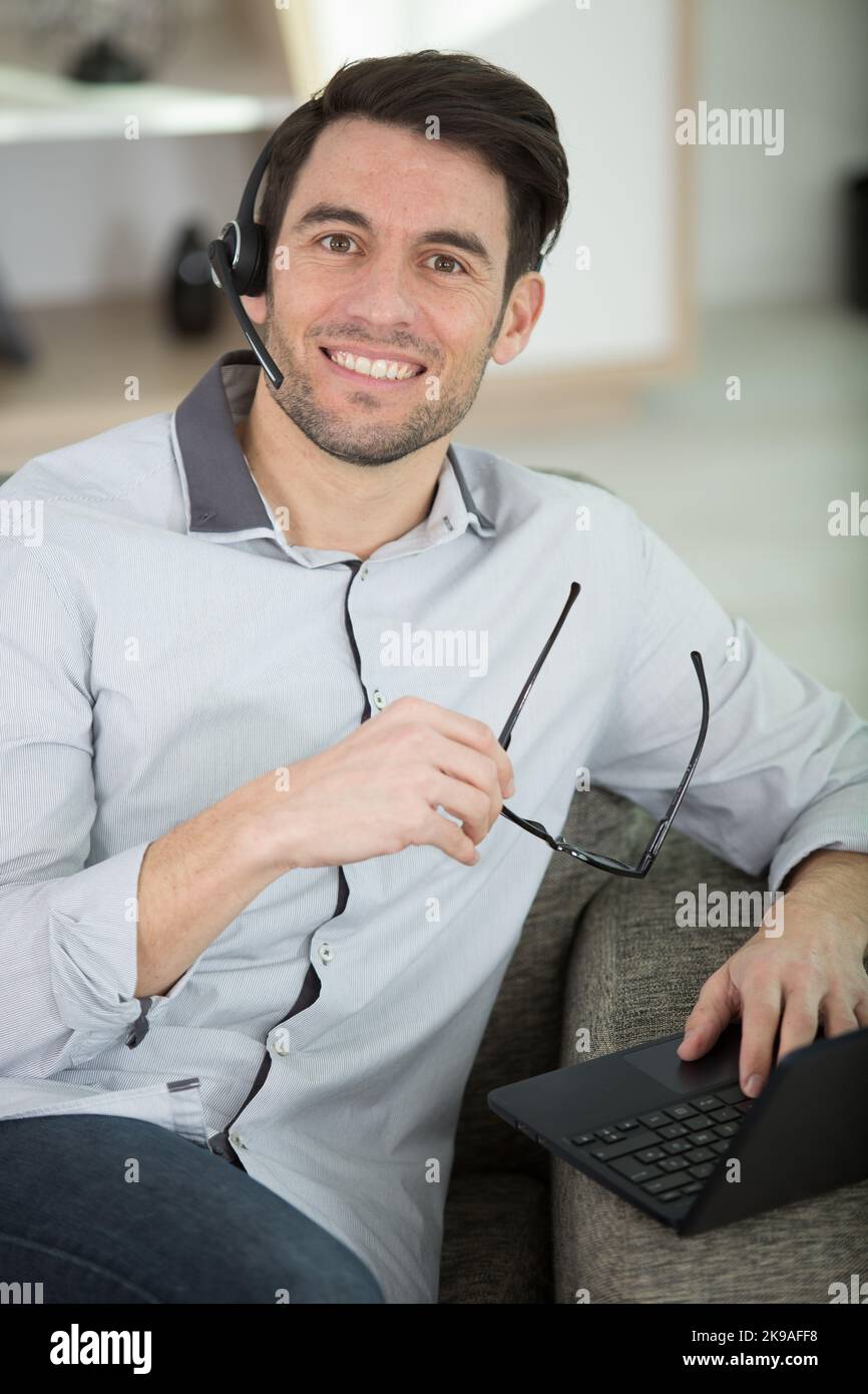 happy man relaxing at home on a sofa Stock Photo - Alamy
