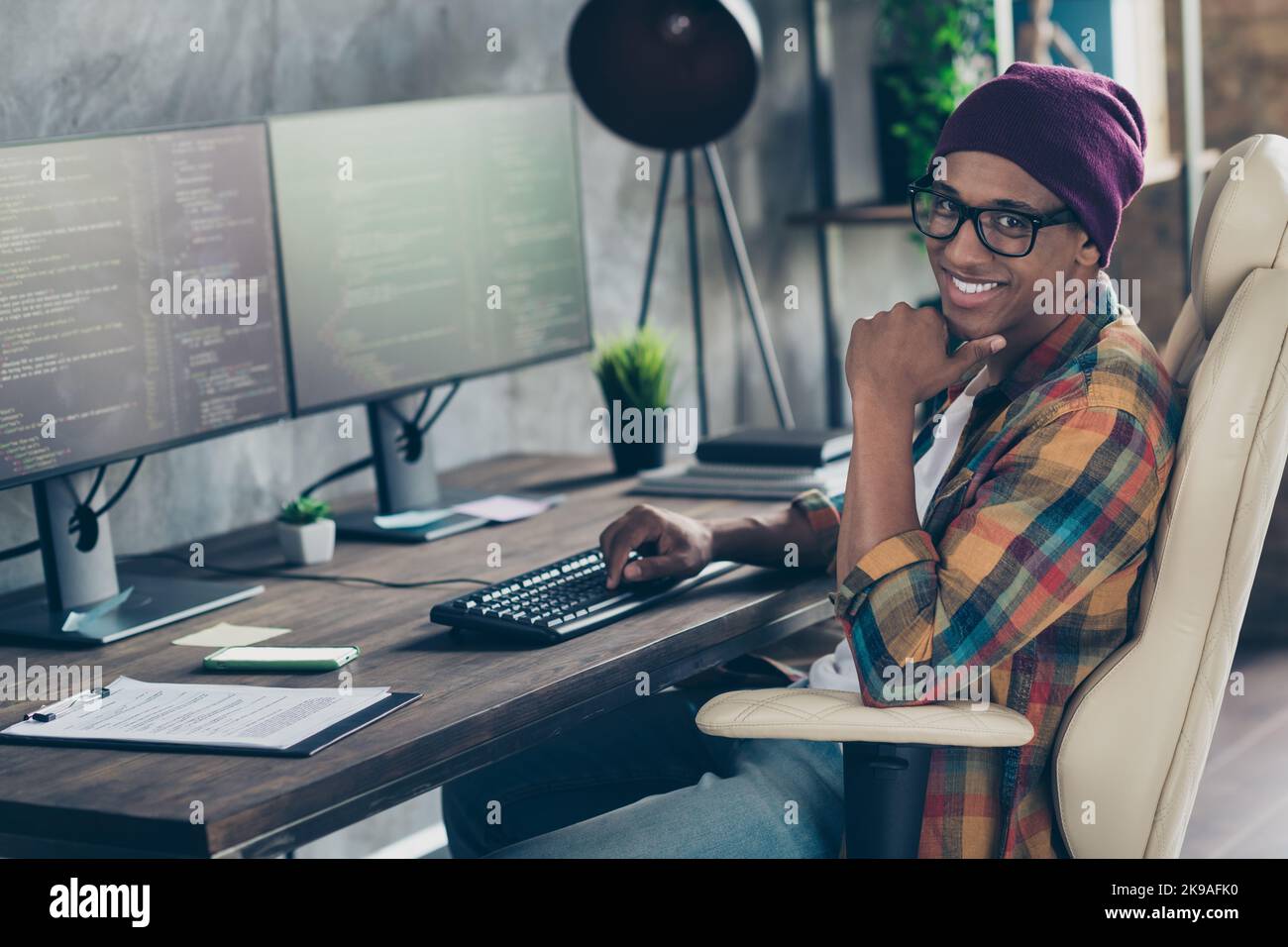 Photo of cheerful cool programmer wear spectacles hat working modern ...