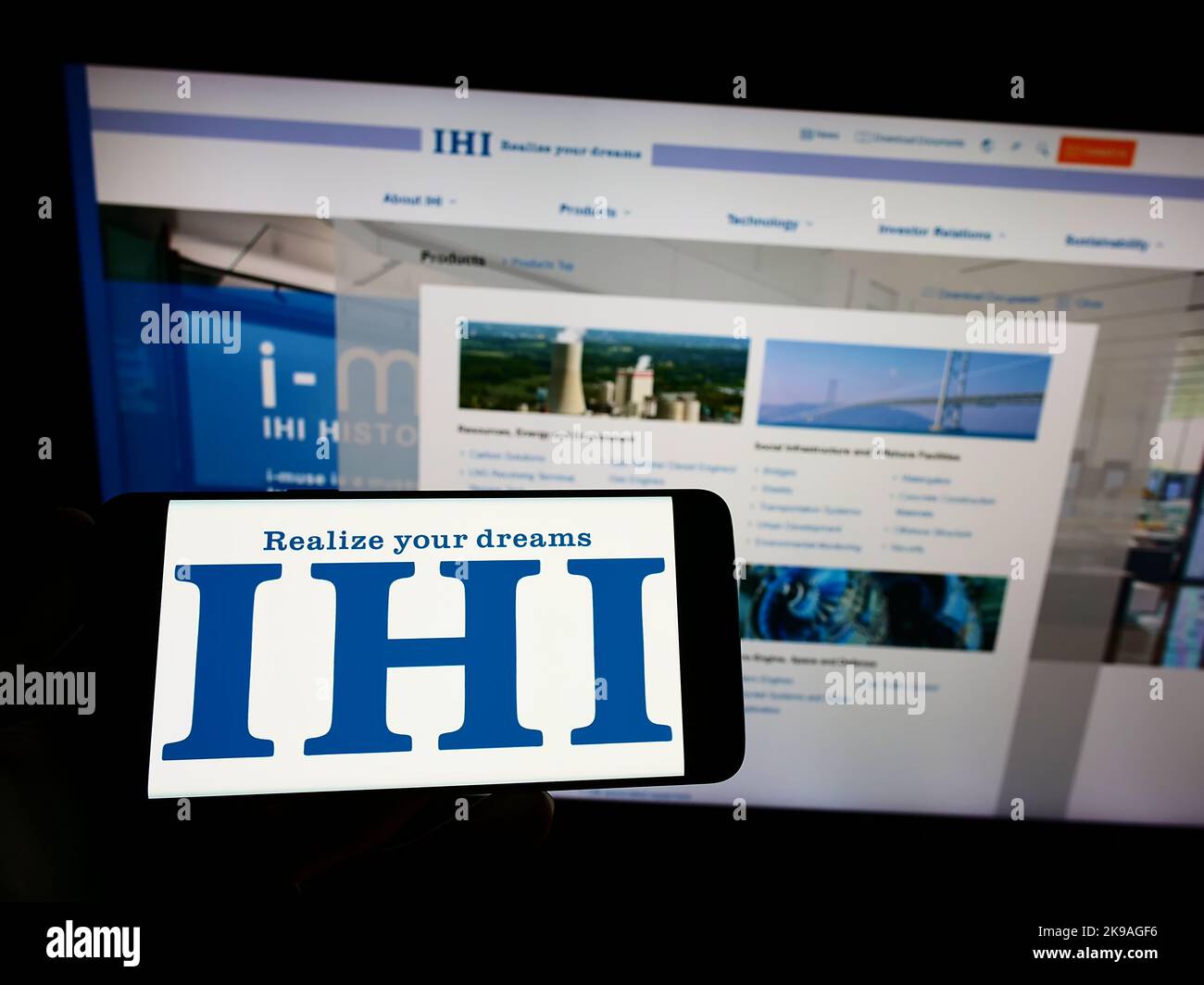 Person holding smartphone with logo of Japanese engineering company IHI ...