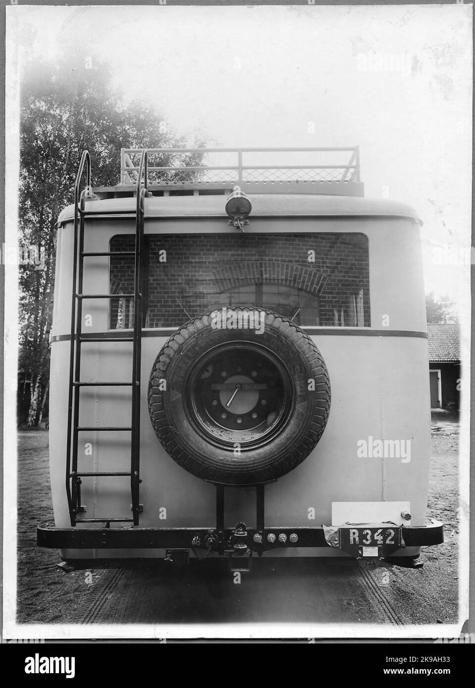 The back of a bus with spare tires, roof racks and ladder Stock Photo ...