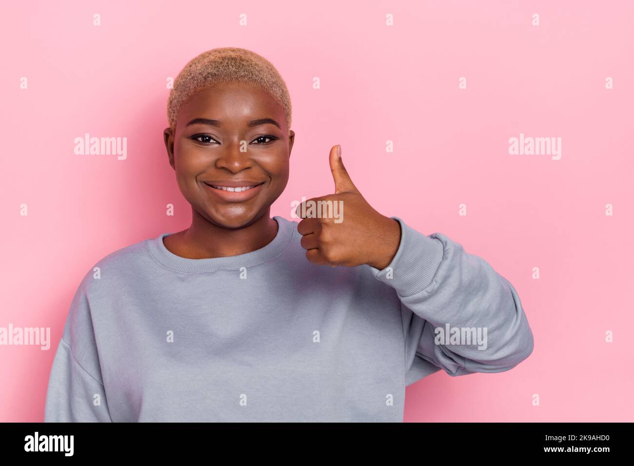 Photo of cheerful charming person hand finger demonstrate thumb up ...