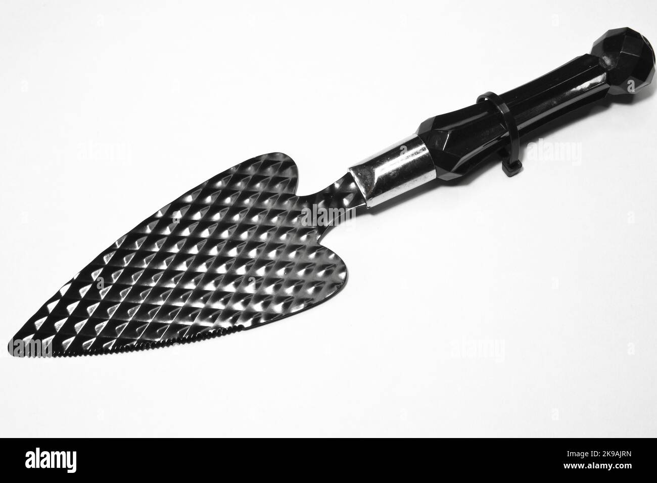 Black spatula in the shape of the heart on white background Stock Photo ...