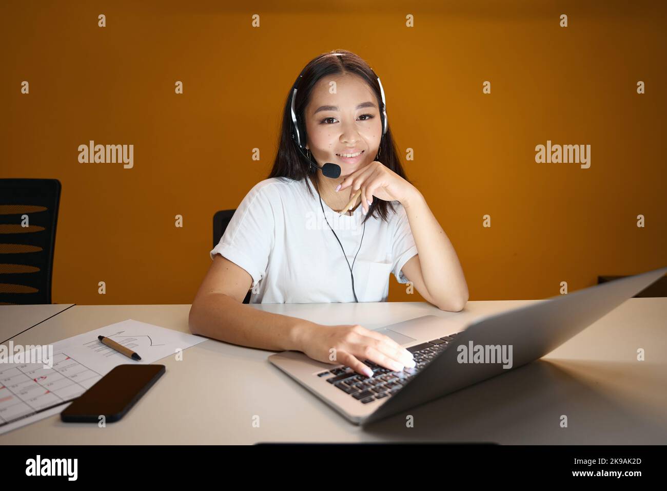Smiling Asian female during the online job interview in the modern ...