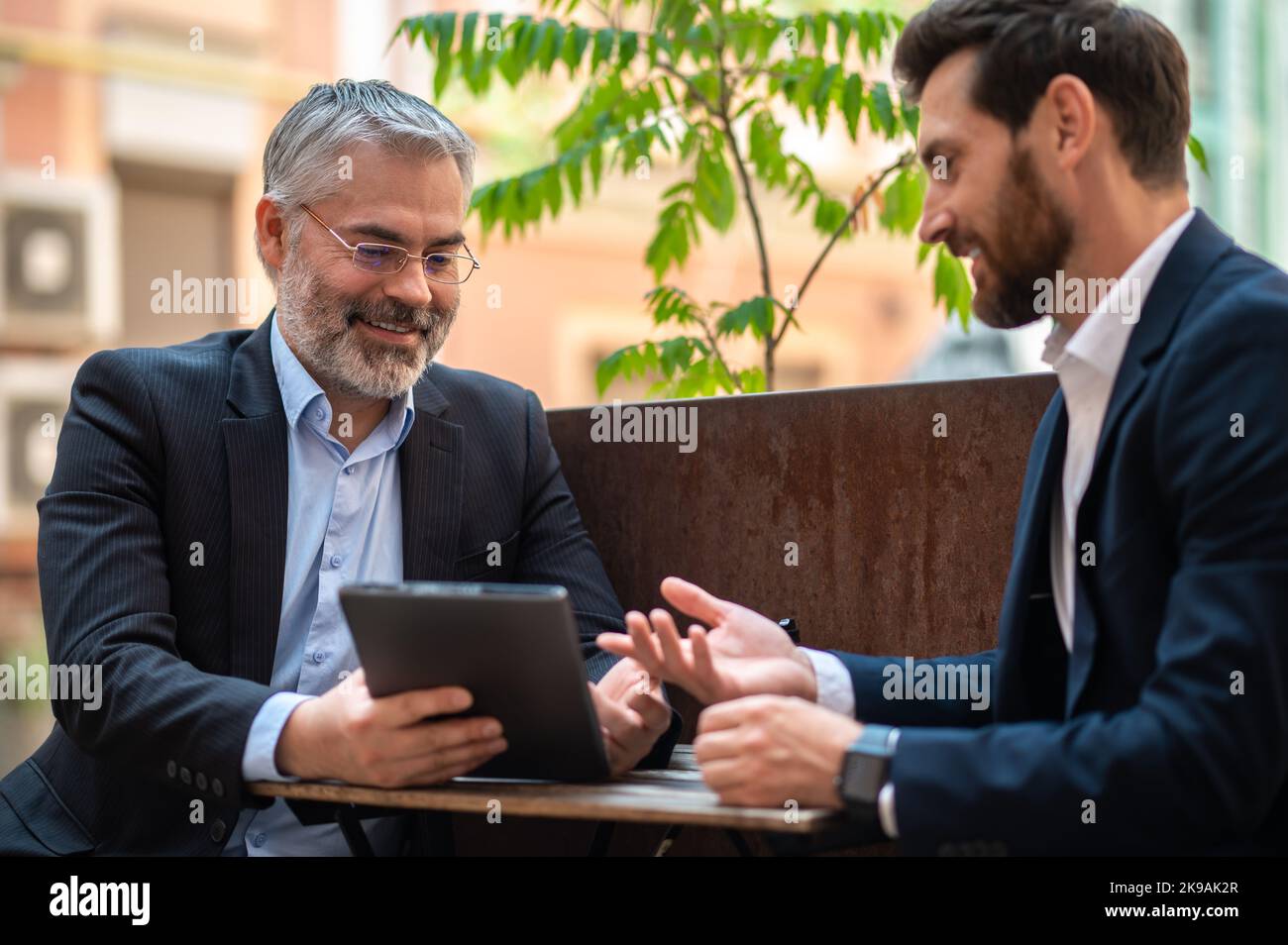 Business partners discussing project details and looking involved Stock ...