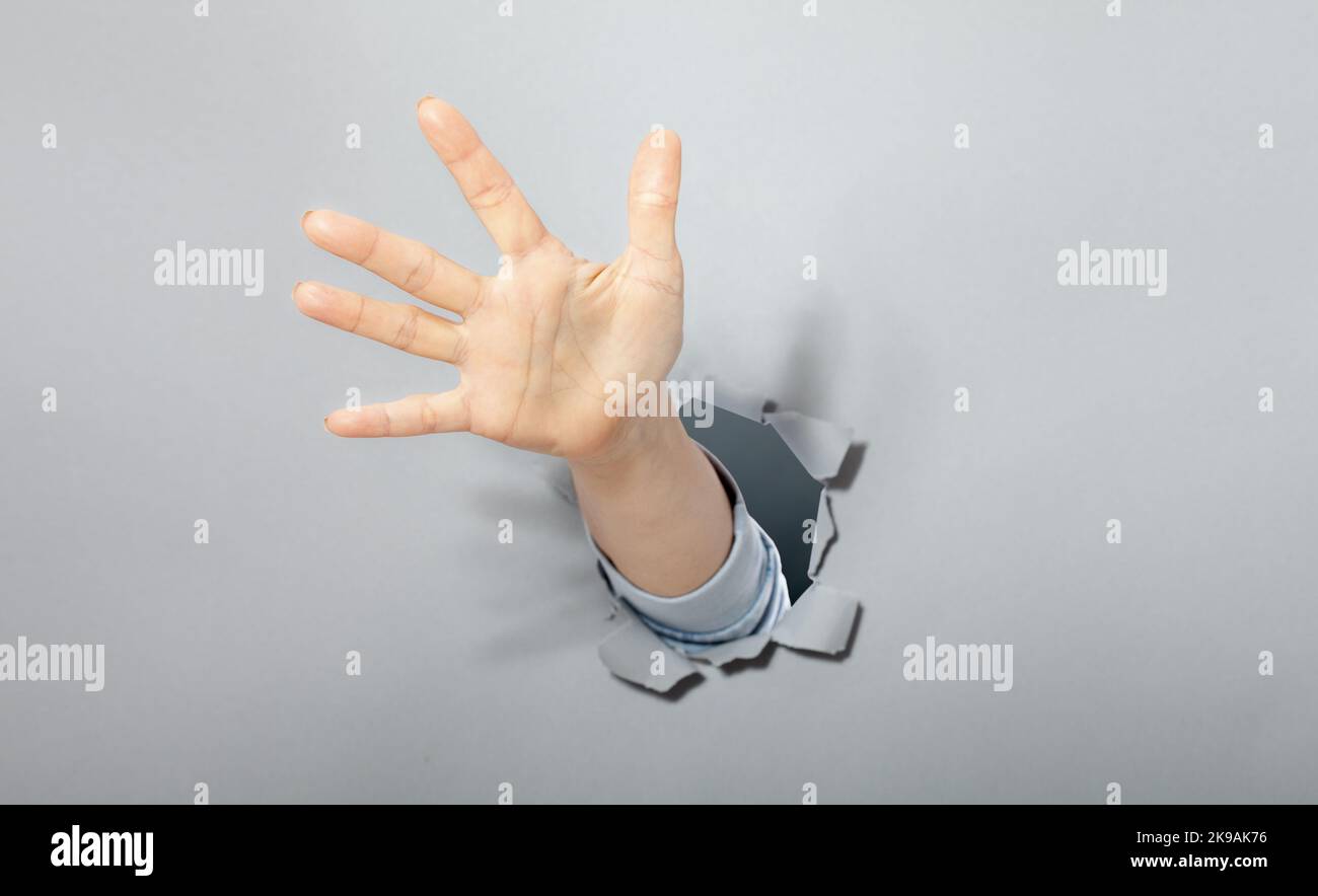 The woman's hand shows with a gesture that everything call for help ...