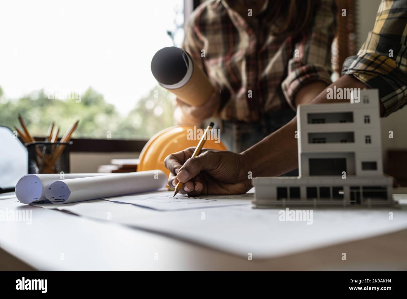 Architect man working with blueprints for architectural plan, engineer ...