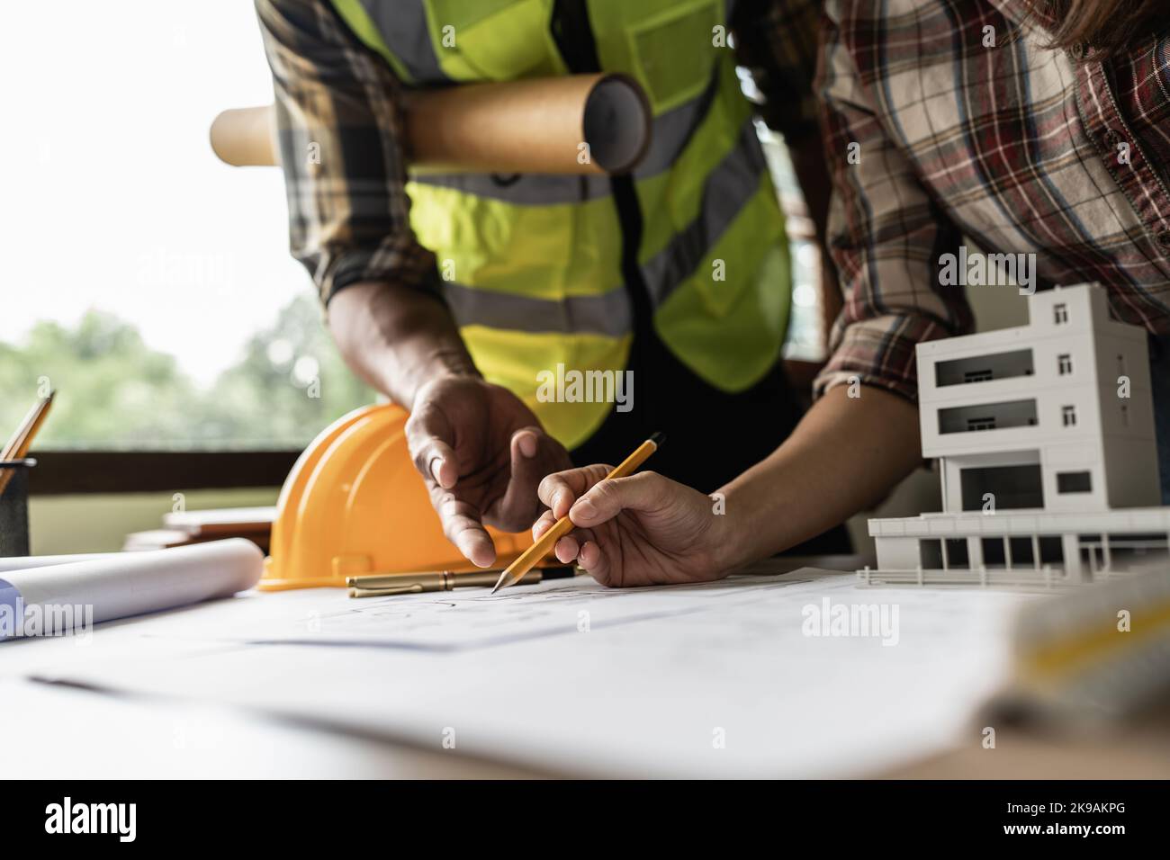 Architect man working with blueprints for architectural plan, engineer ...