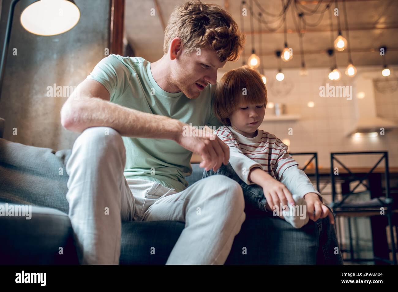 Father showing his little son how to get dressed Stock Photo - Alamy