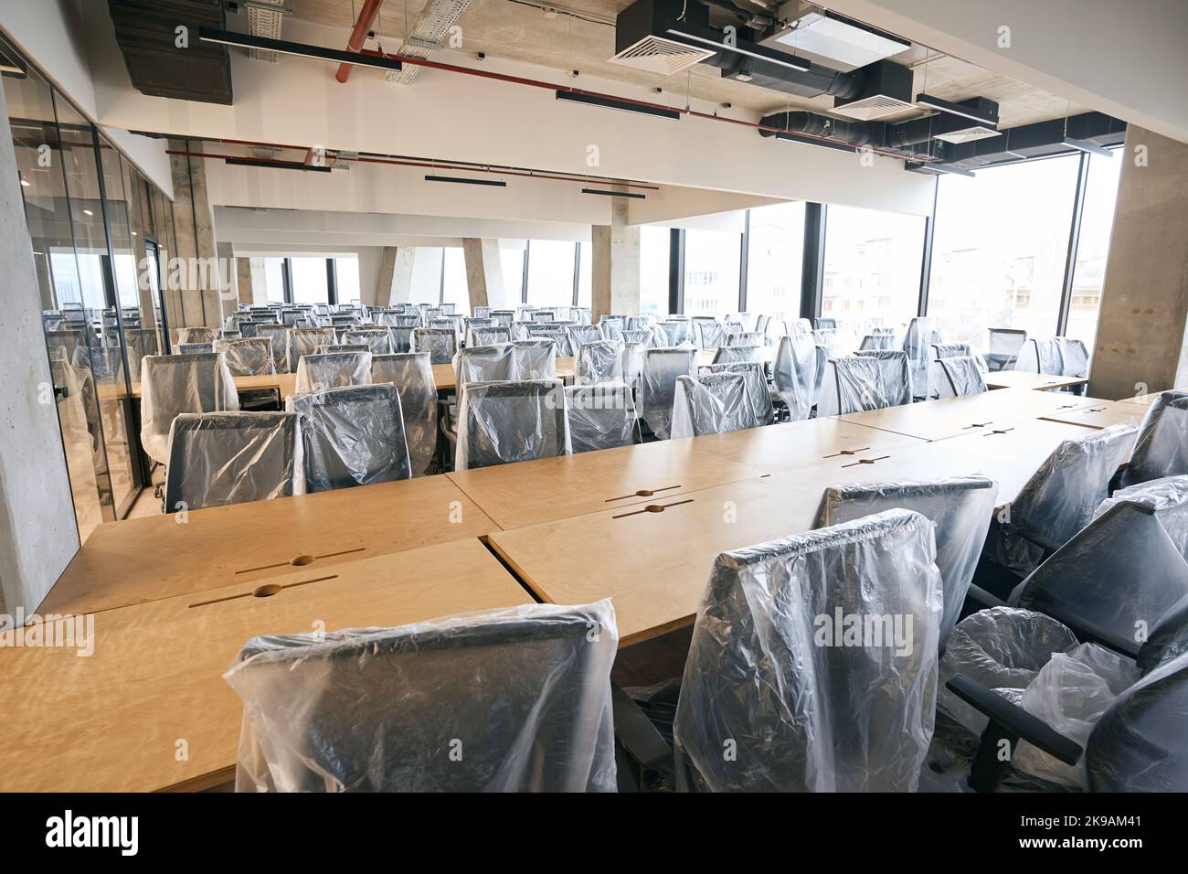 Modern coworking area after disinfection, huge windows, high-tech ...