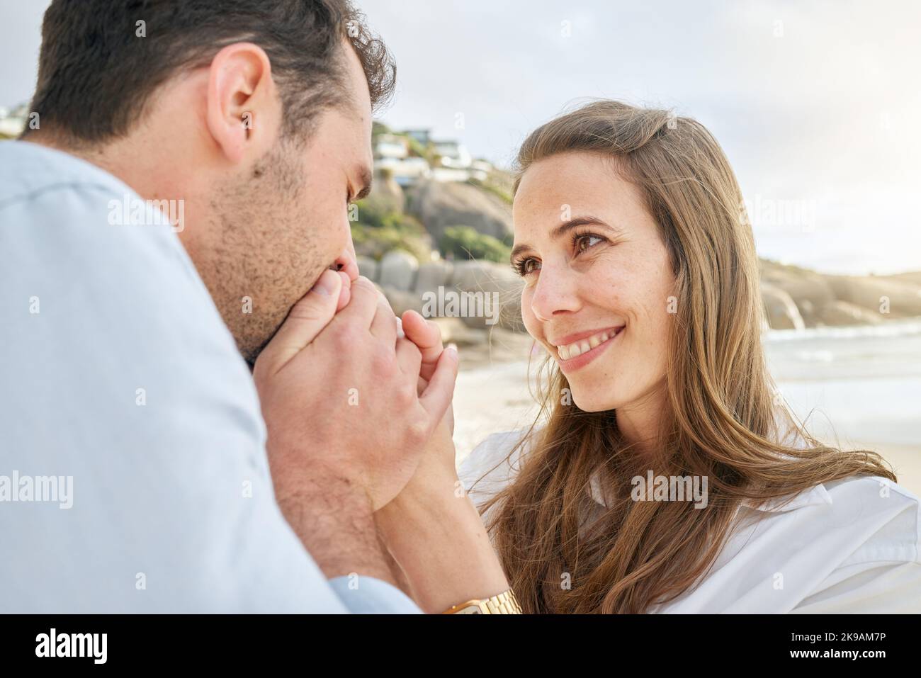 Kiss hands, couple and love, happy together on beach, adventure and ...