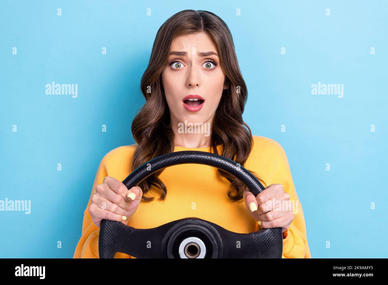 Photo portrait of attractive young girl steering wheel astonished ...