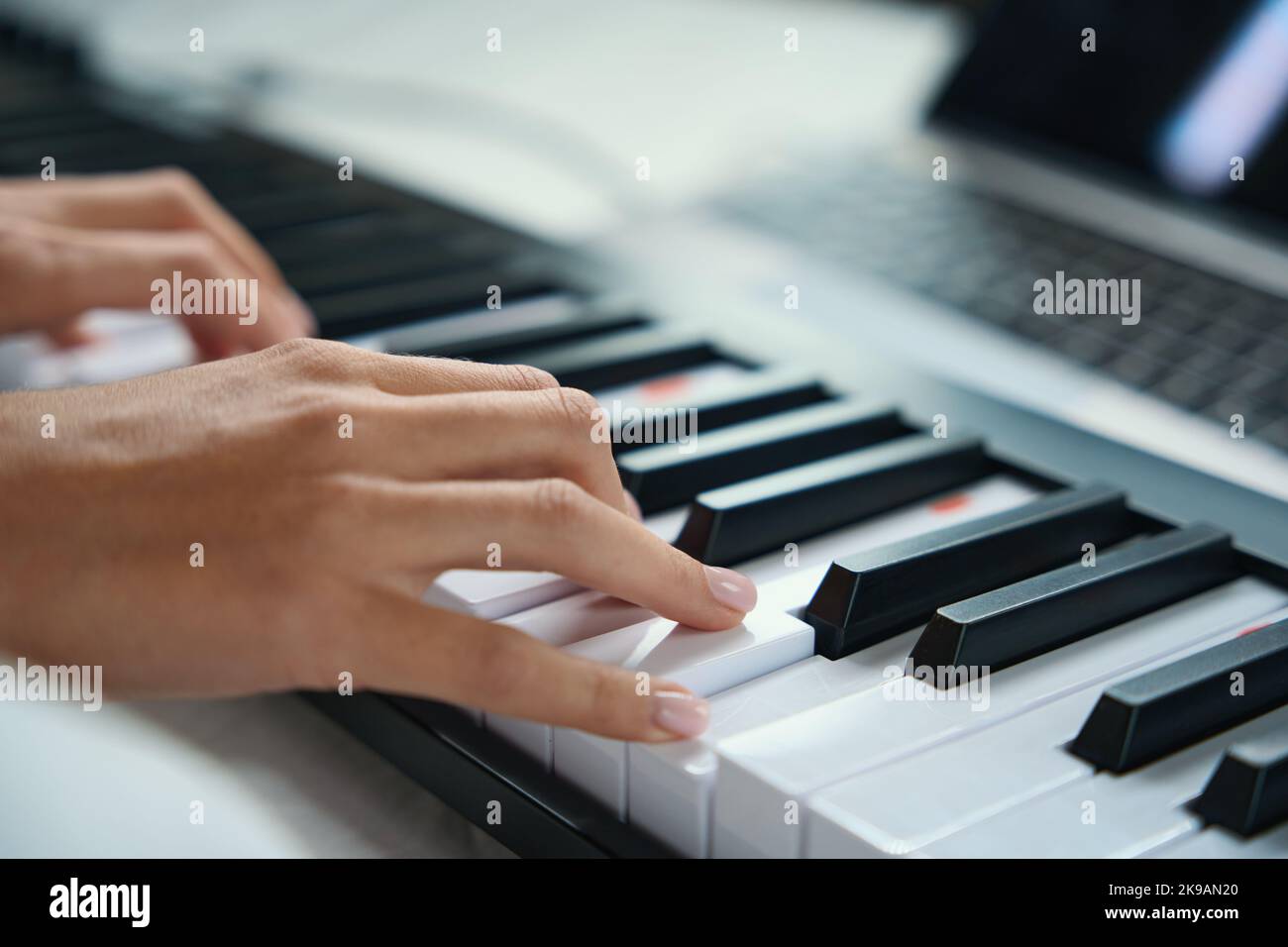 Woman pressing the black and white keys of musical instrument Stock ...