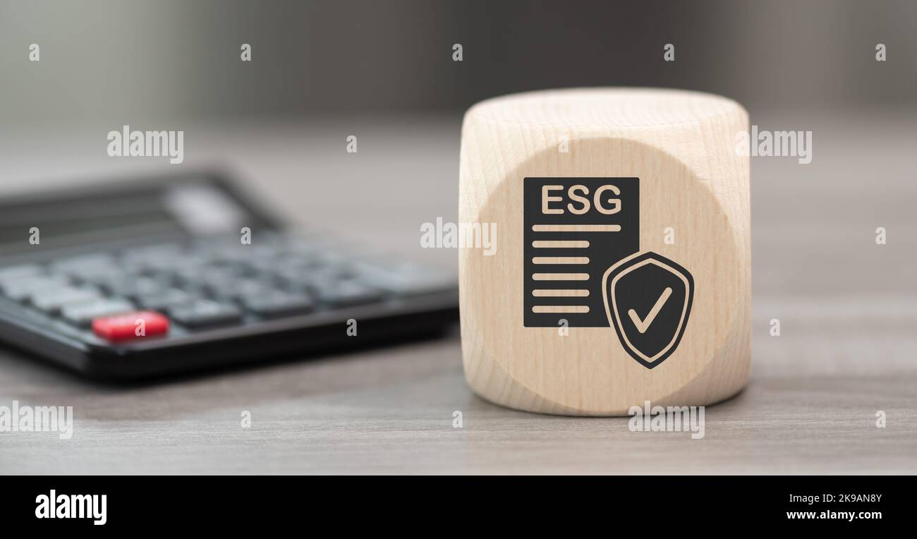 Wooden block with symbol of esg concept and calculator on background ...