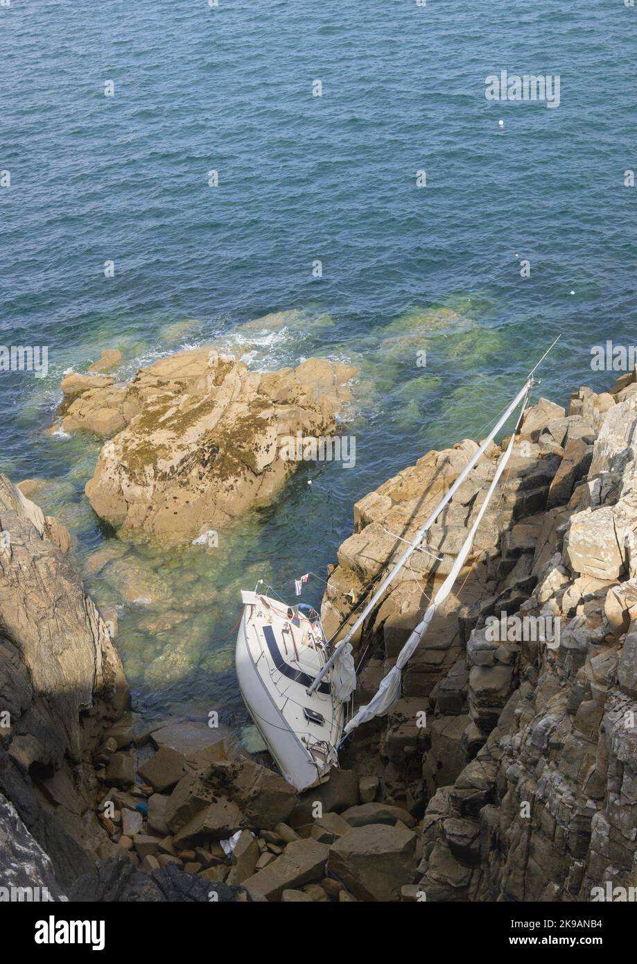 Abandoned sailing boat run aground and damaged on rocks in Douarnenez ...
