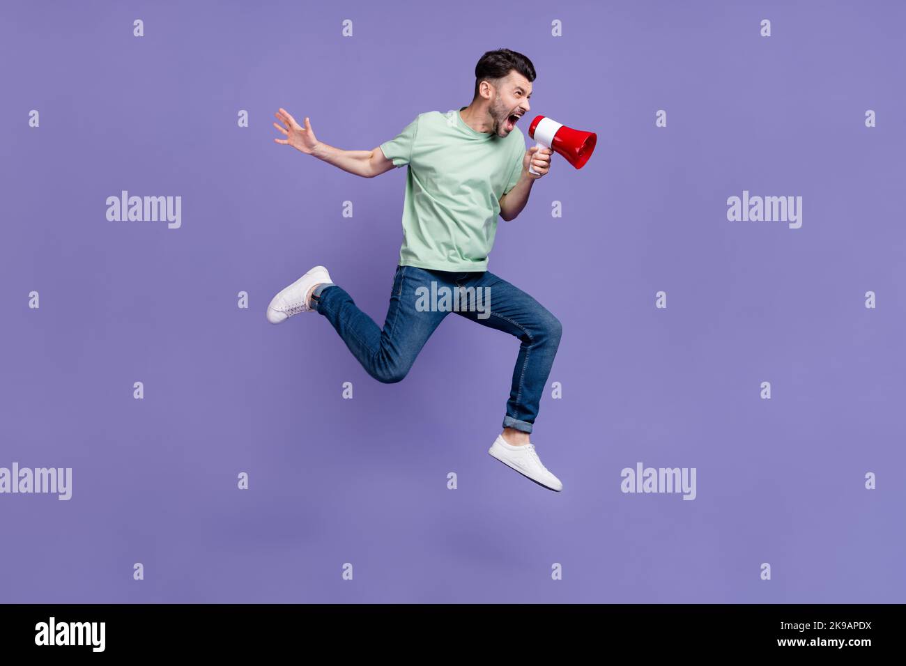 Full body photo of attractive young man jump hold loudspeaker angry ...