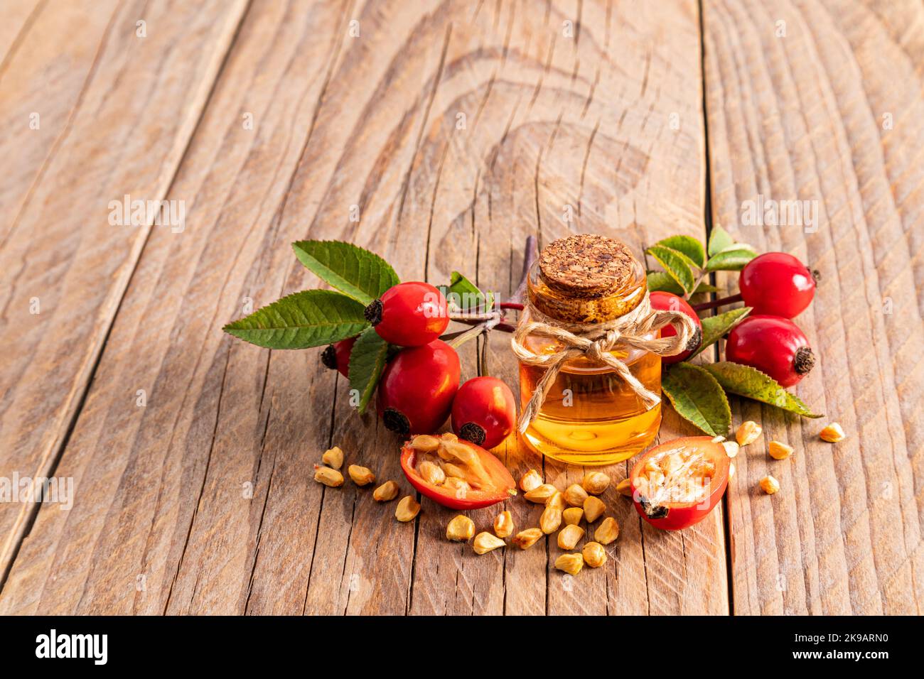 a glass bottle with a cork with natural rosehip seed oil on the village ...