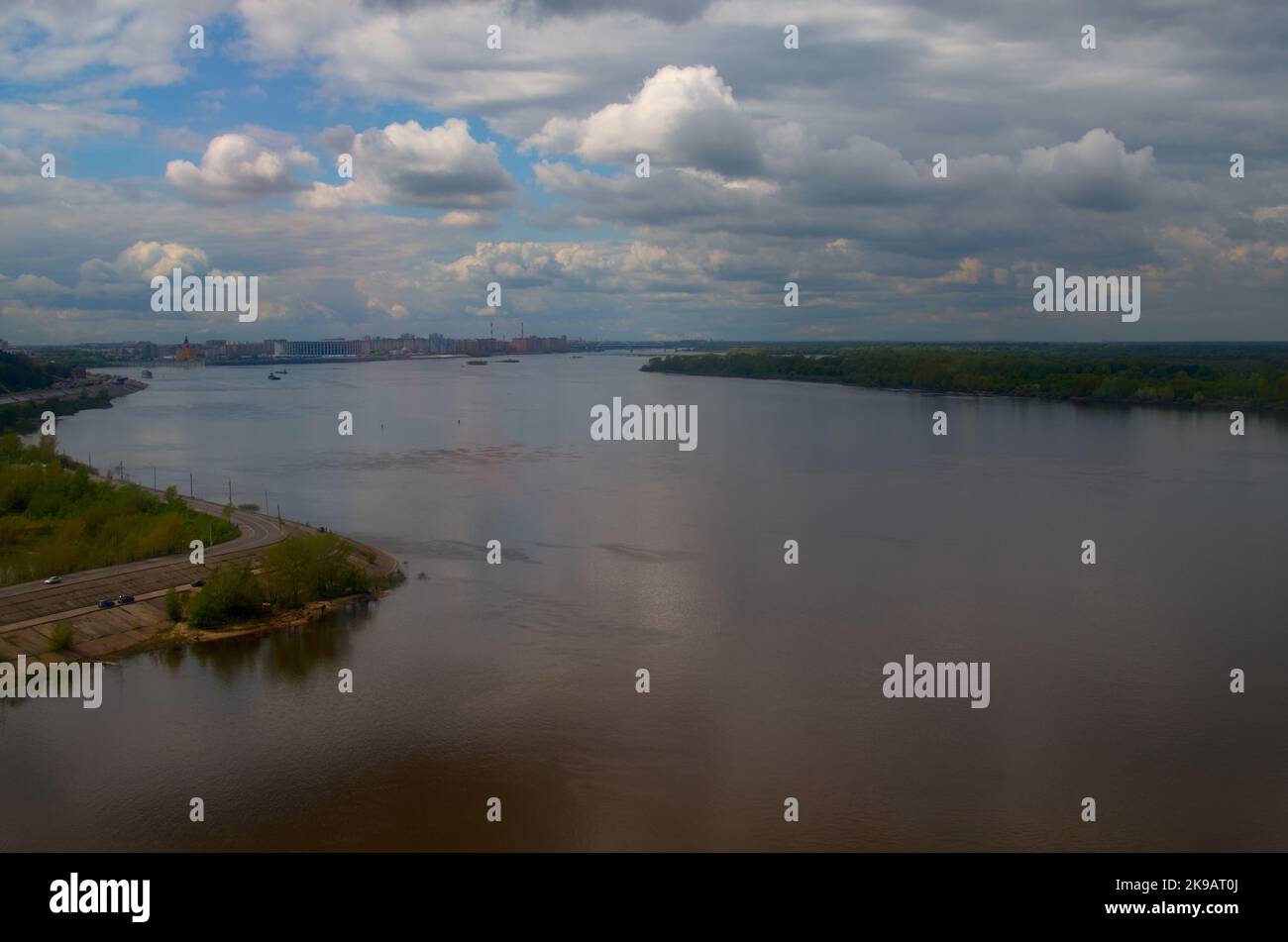 River water landscape. Blue sky with clouds and city on the background ...