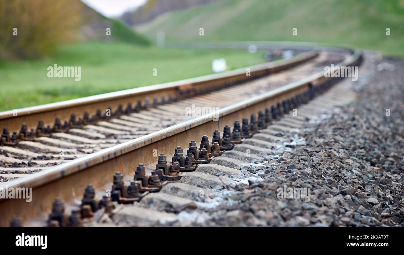 Selective focus railway track turns and twists between hills. Empty ...