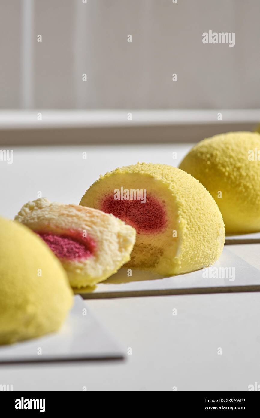 Modern European mini-mousse desserts covered in the form of a lemon on ...