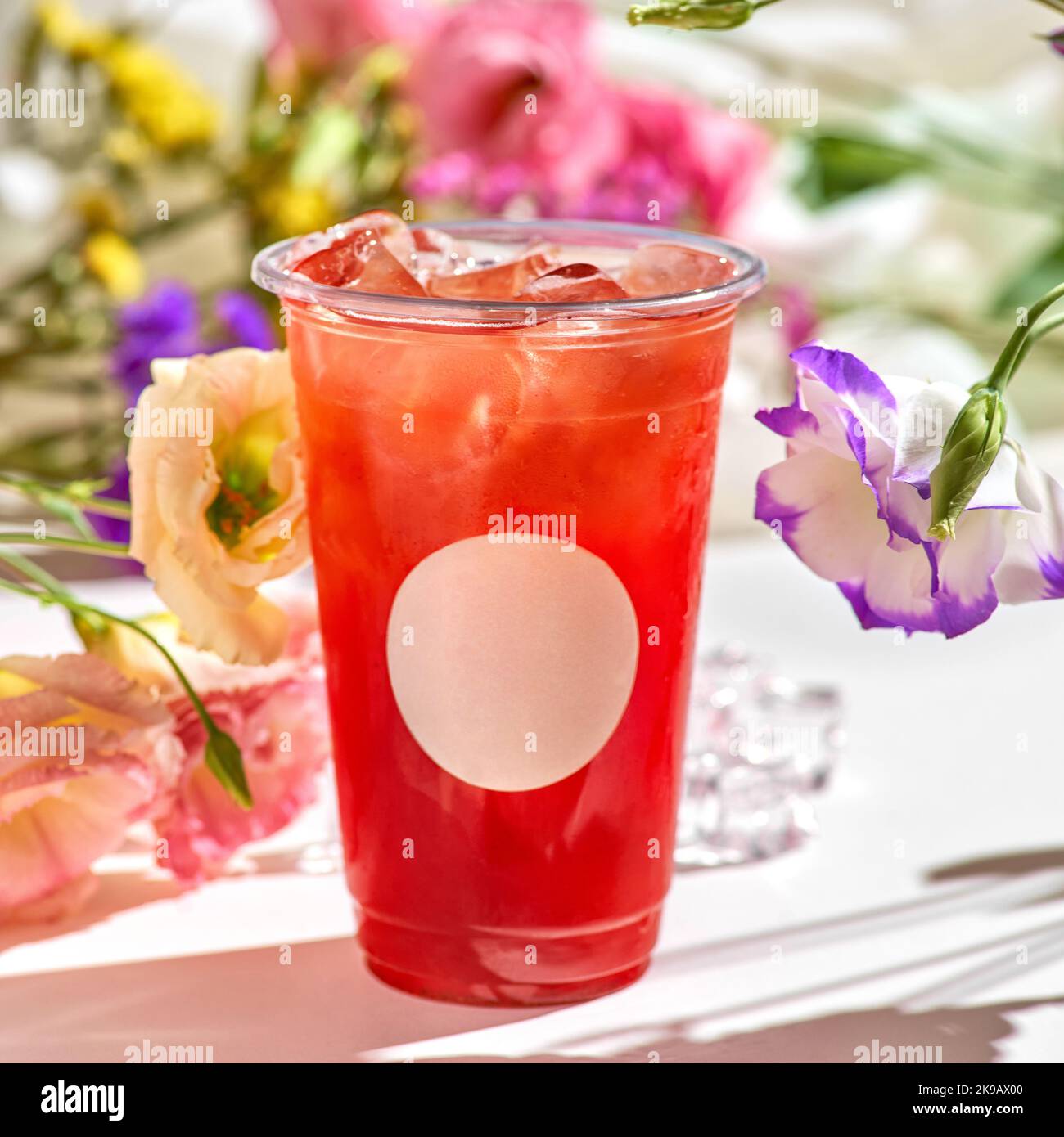 cold summer lemonade with strawberries and ice in plastic glass to take ...